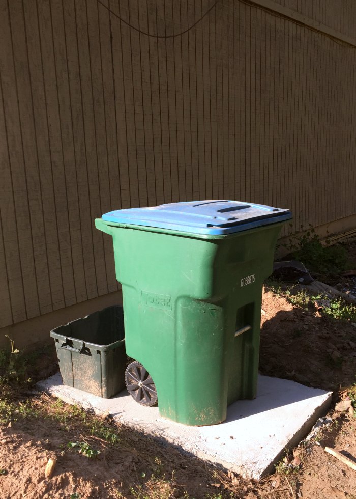 Laying a DIY Concrete Slab for Hiding City Trash Cans